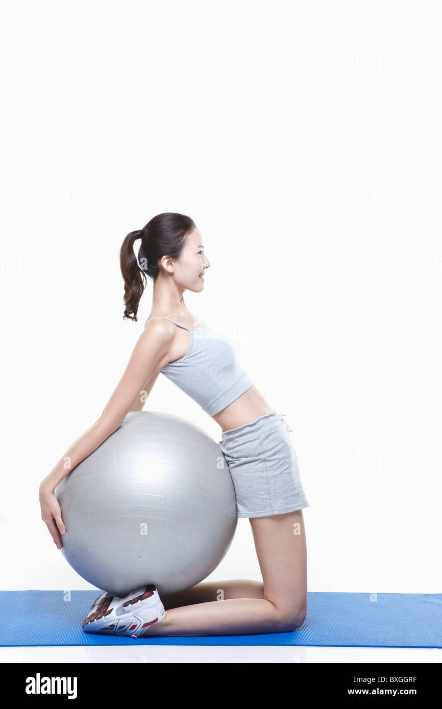 woman is stretching with gym ball Stock Photo - Alamy