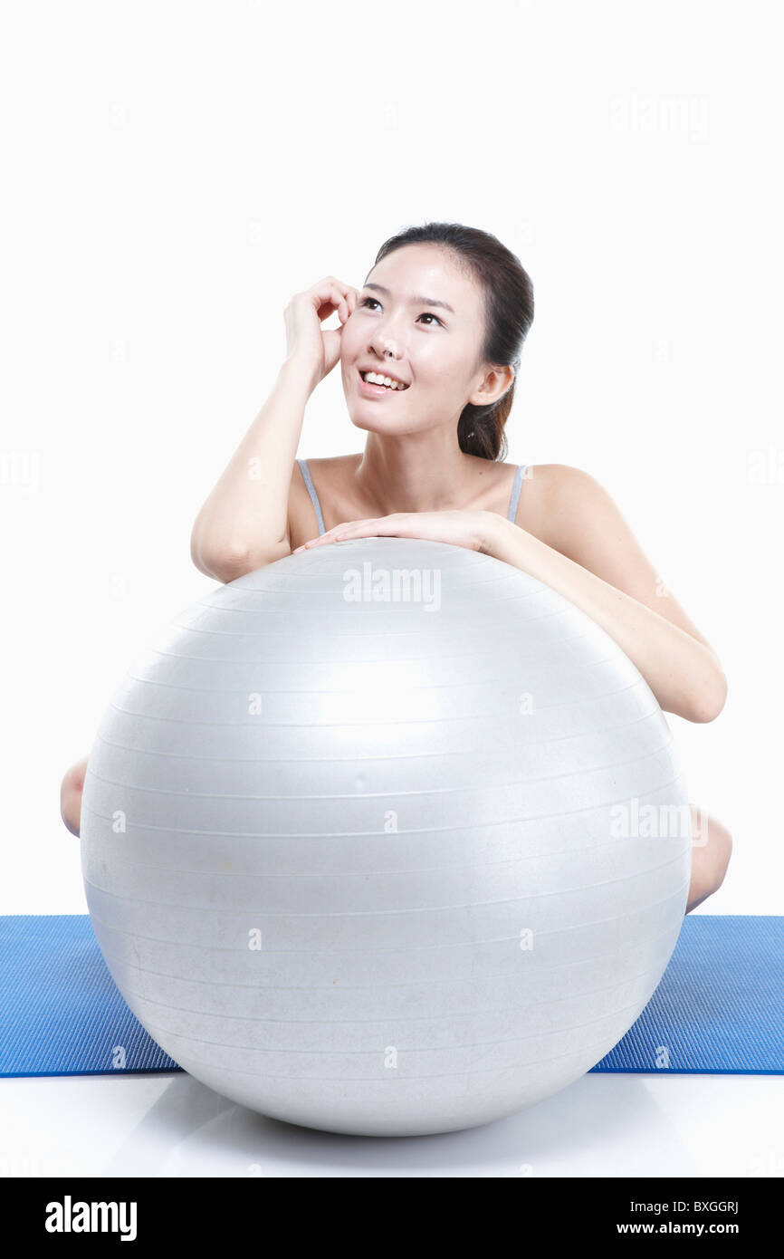 woman is stretching with gym ball Stock Photo - Alamy