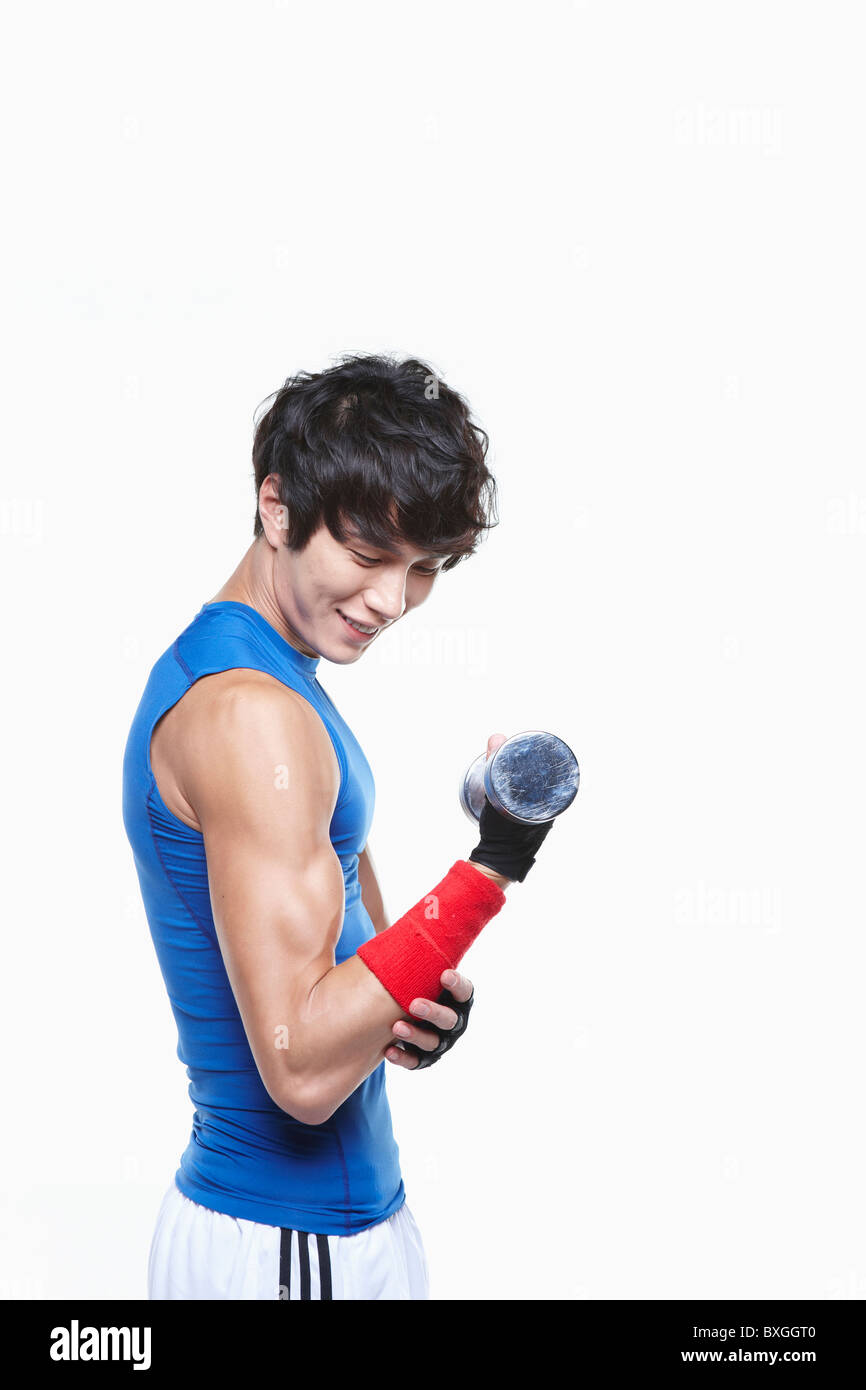 guy is stretching with dumbbell Stock Photo - Alamy