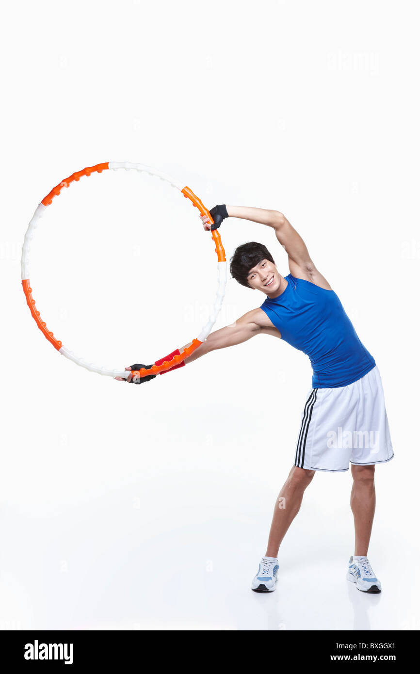 guy stretching with hoola hoop Stock Photo - Alamy
