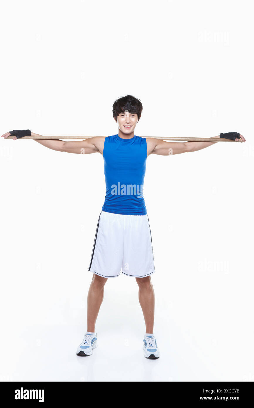 guy stretching with bar Stock Photo - Alamy