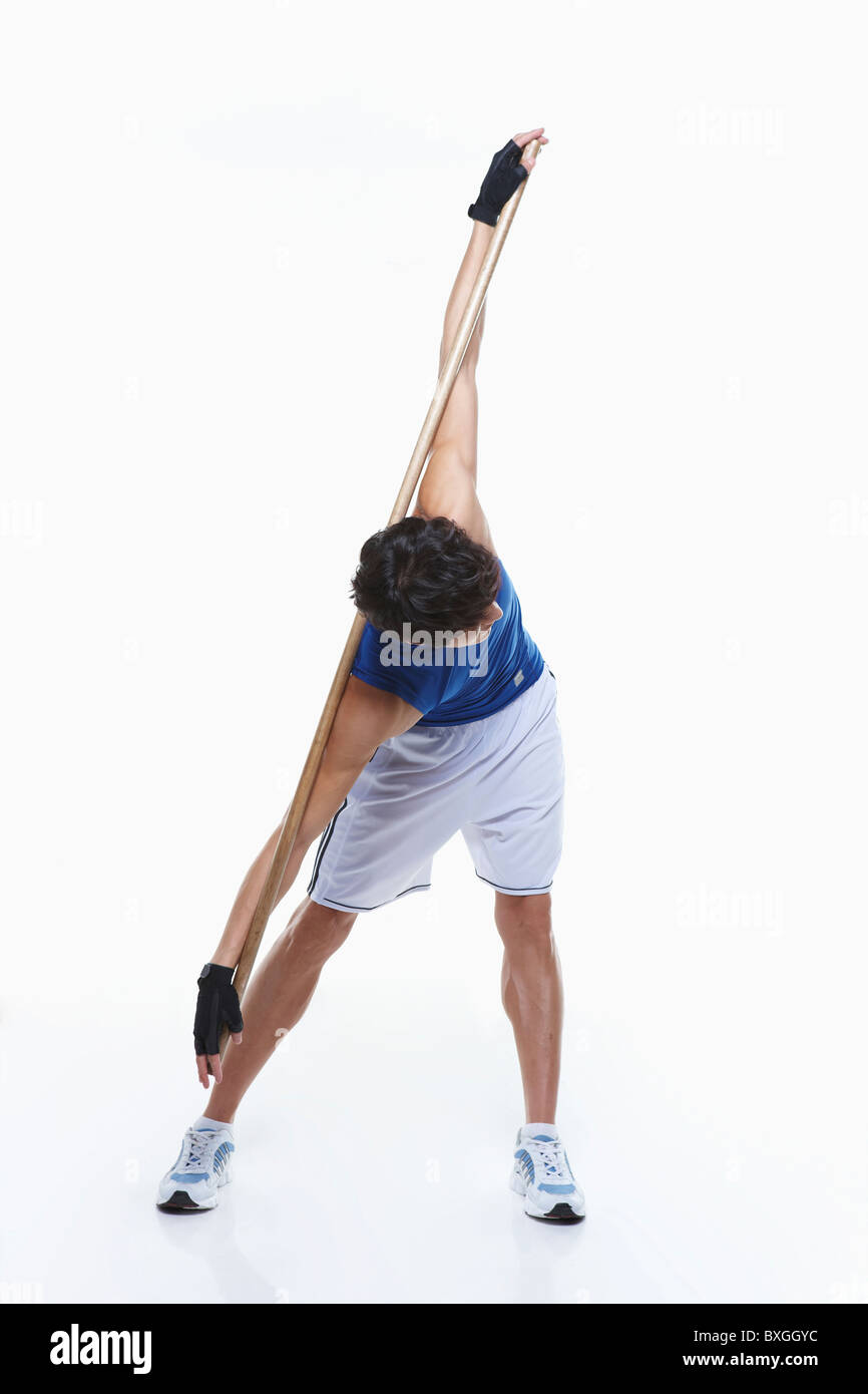 guy stretching with bar Stock Photo - Alamy