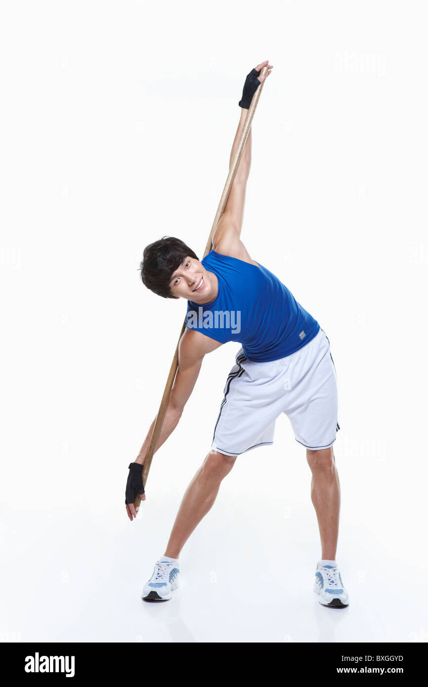 guy stretching with bar Stock Photo - Alamy