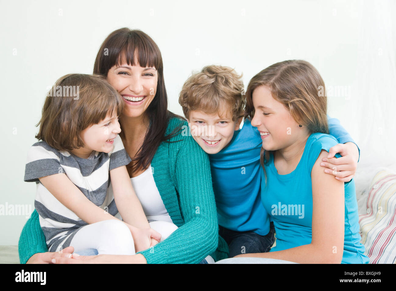 Mother and children laughing Stock Photo - Alamy