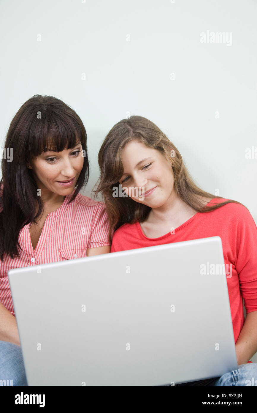 Mother and daughter in front of computer Stock Photo - Alamy