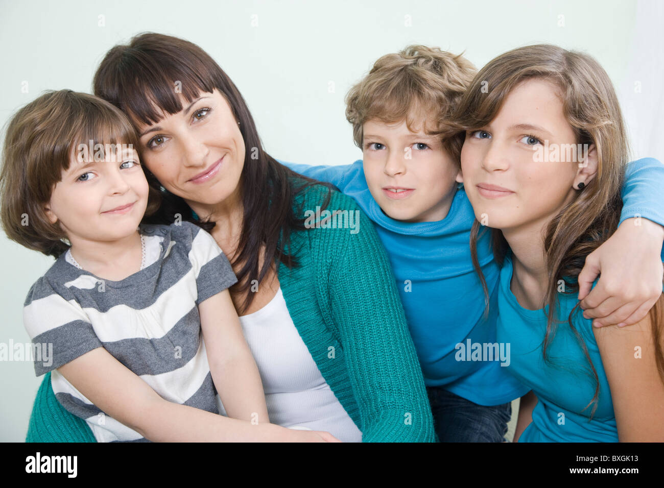 Mother and children embracing Stock Photo - Alamy