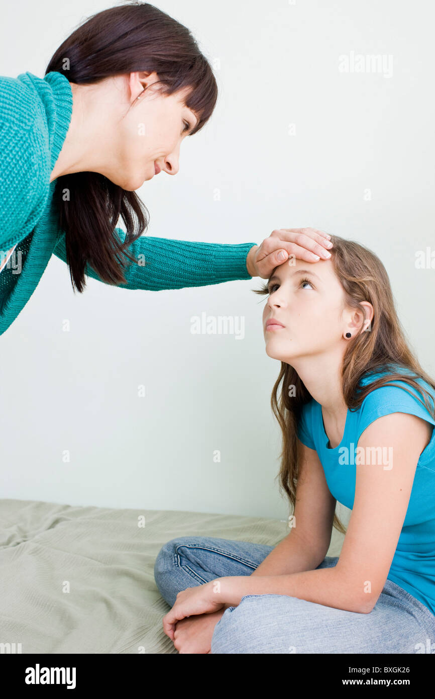 Mother taking care of sick daughter Stock Photo - Alamy