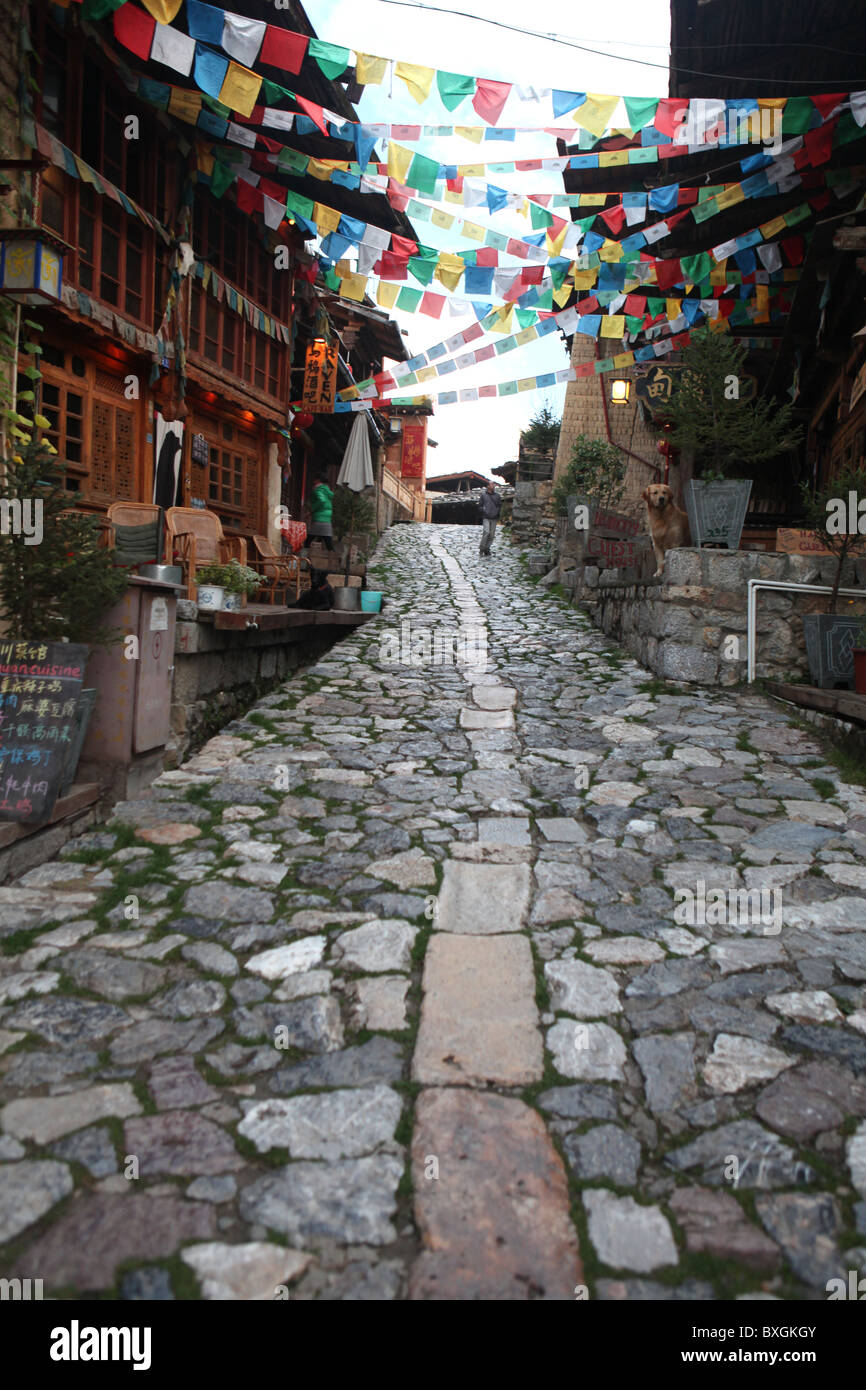 A traditional tibetan street with tibetan flags in the town of Shangri ...