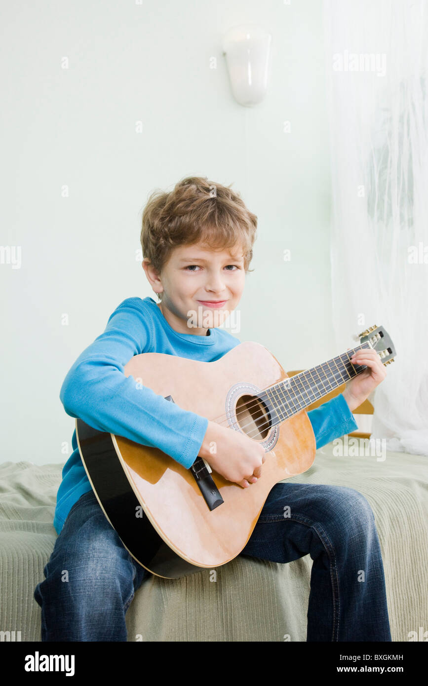 Boy playing guitar Stock Photo - Alamy