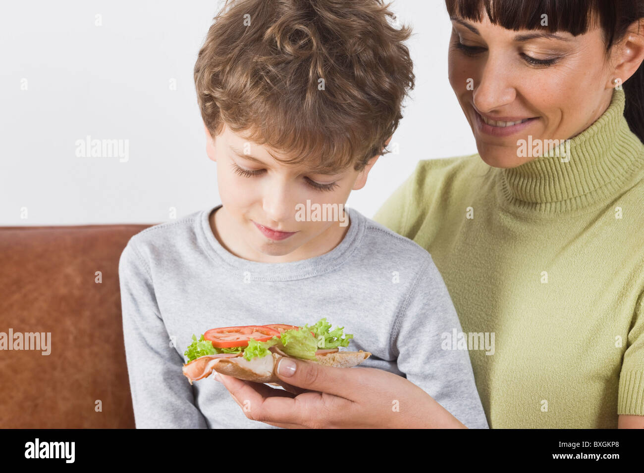 Mother giving son a sandwich Stock Photo - Alamy