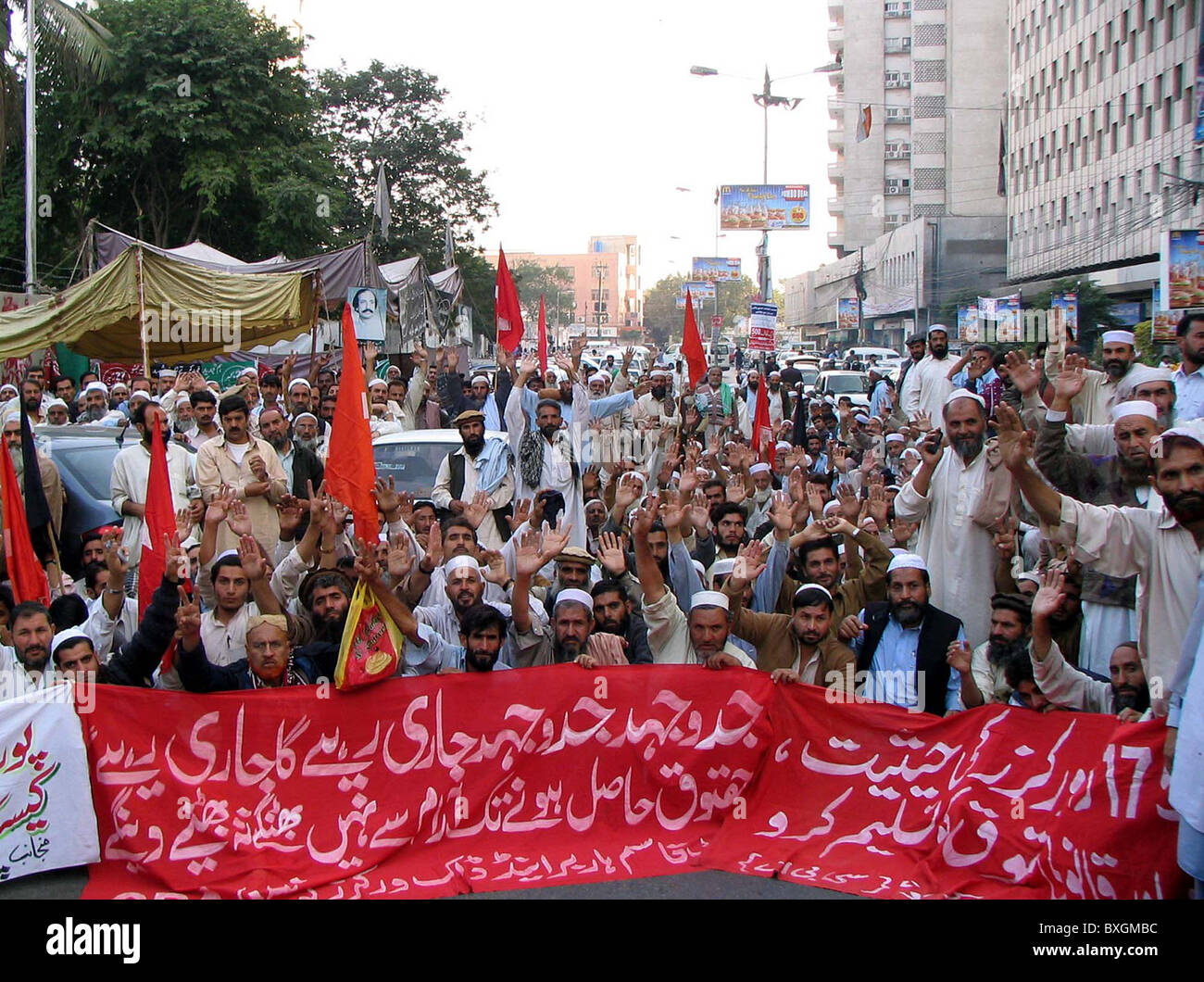 Members of Qasim Harbor and Dock Workers Union chant slogans in favor ...