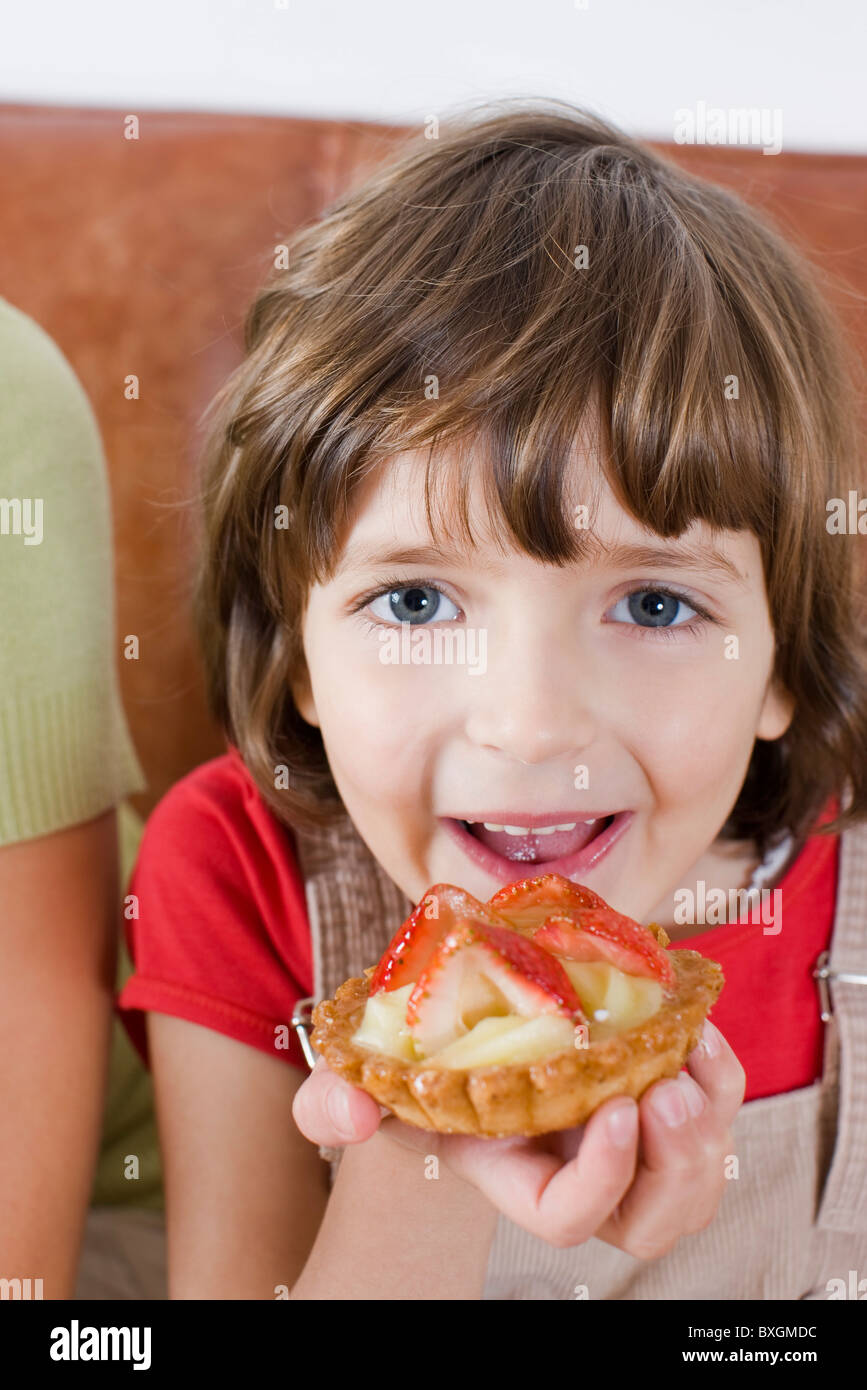 Young girl eating cake Stock Photo - Alamy