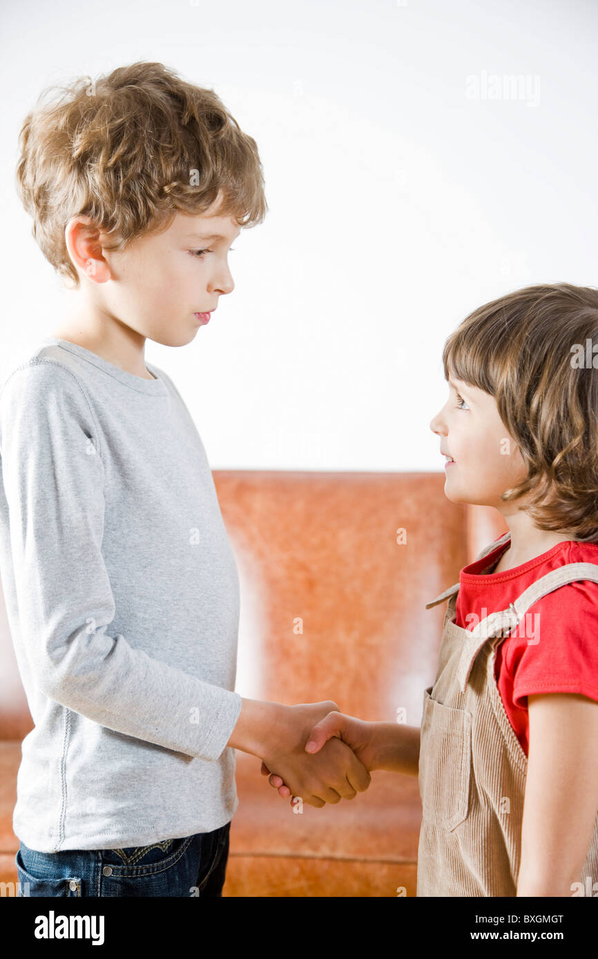 Brother and sister shaking hands Stock Photo - Alamy