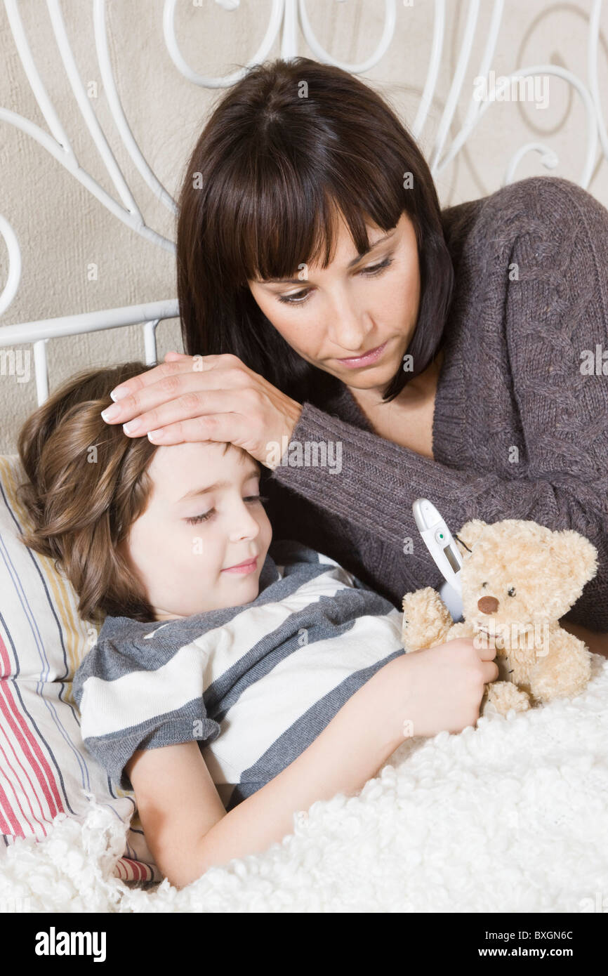 Mother taking care of sick daughter Stock Photo - Alamy