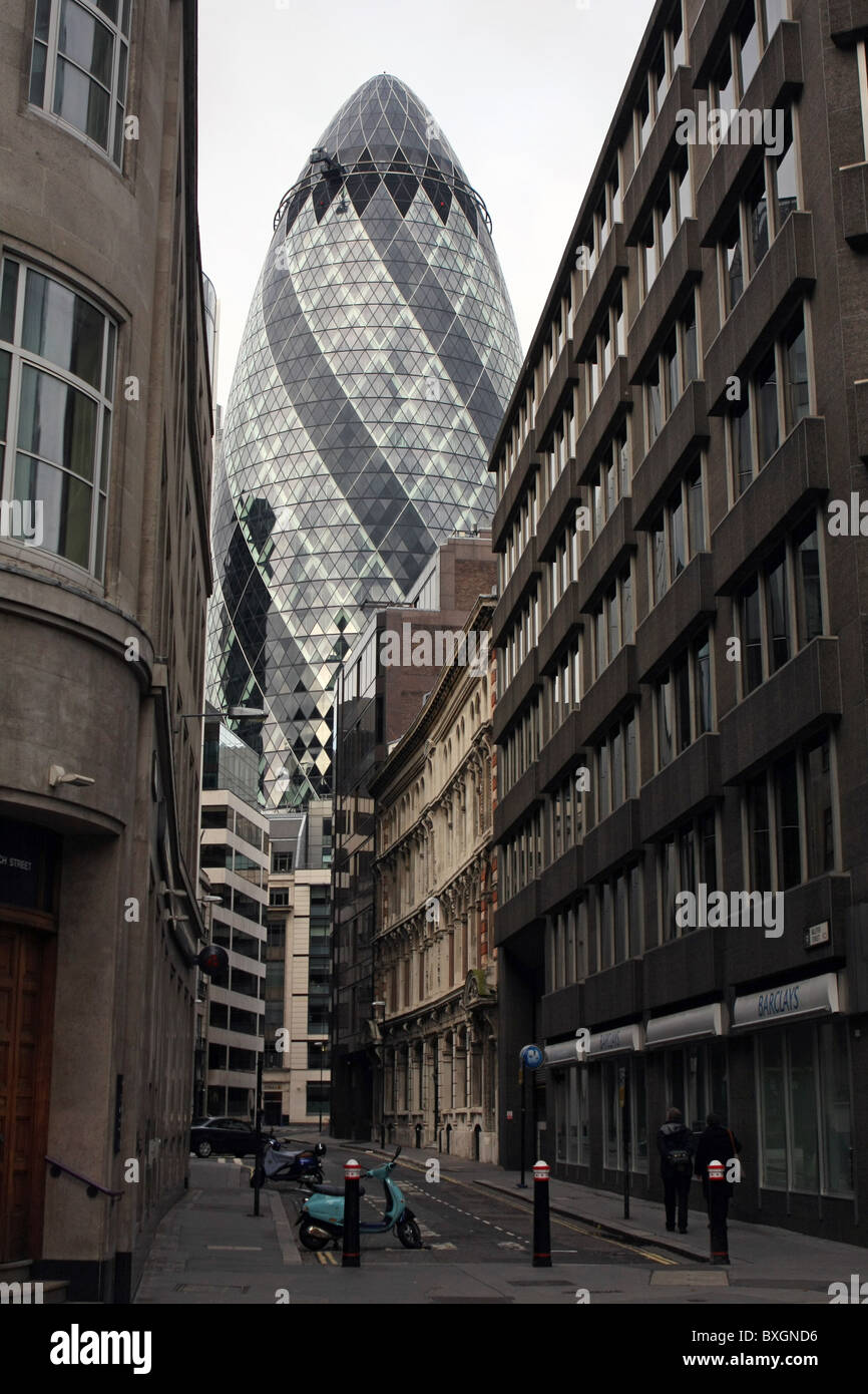 A view of the Gherkin building in London, England, looming over ...