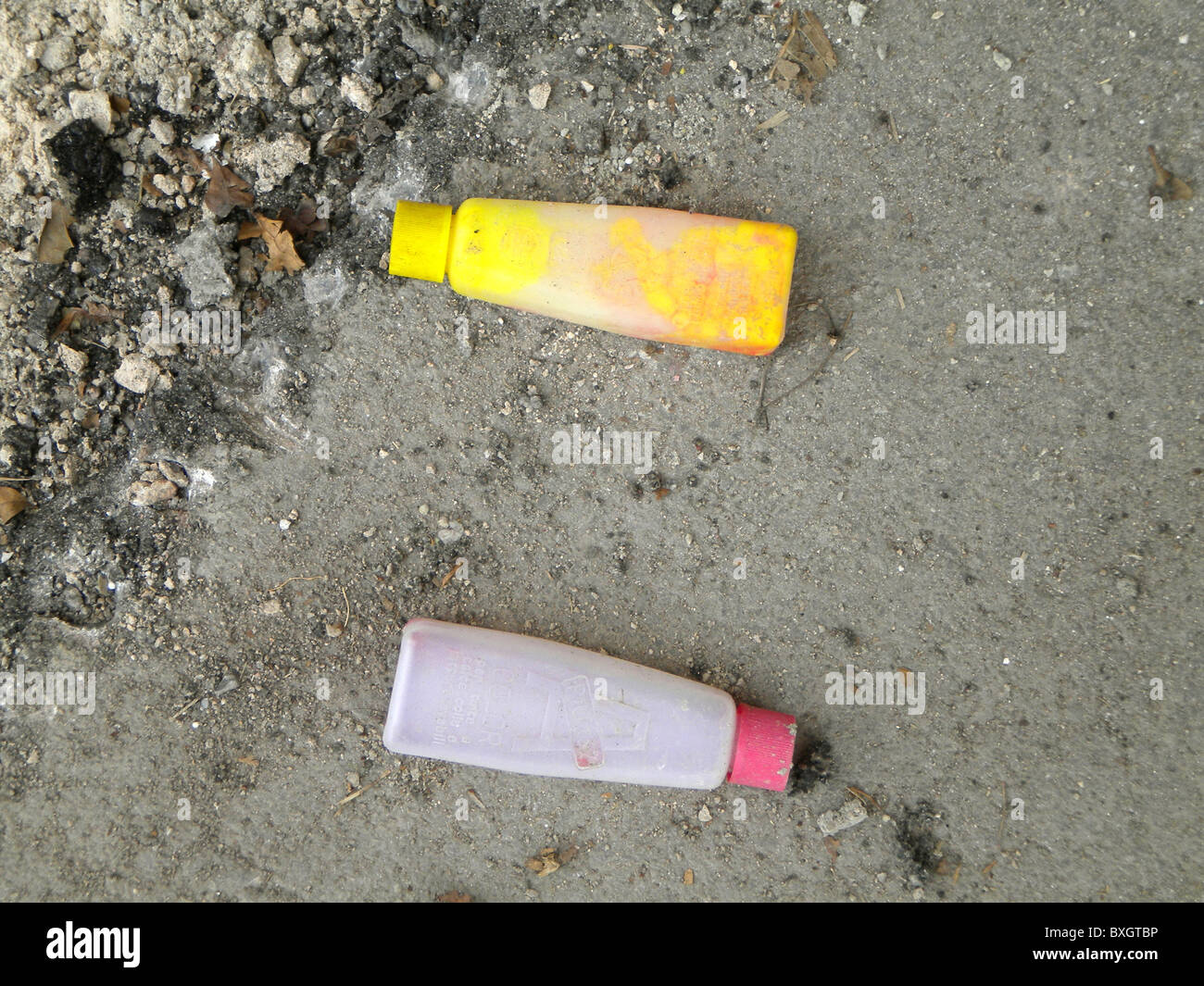tubes of yellow and red on the ground waste and rubbish Stock Photo - Alamy