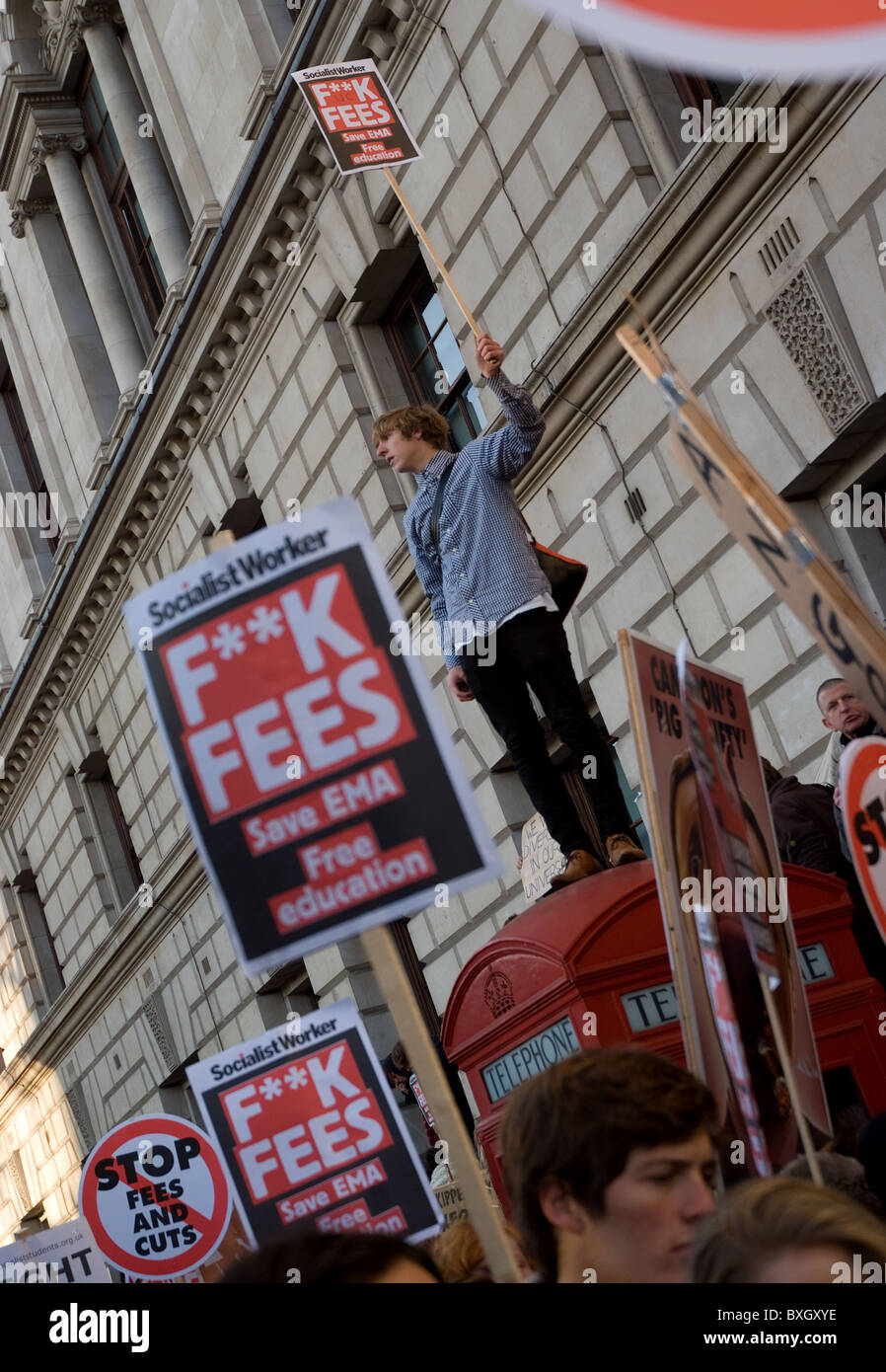a student stands on top of a telephone box Stock Photo - Alamy