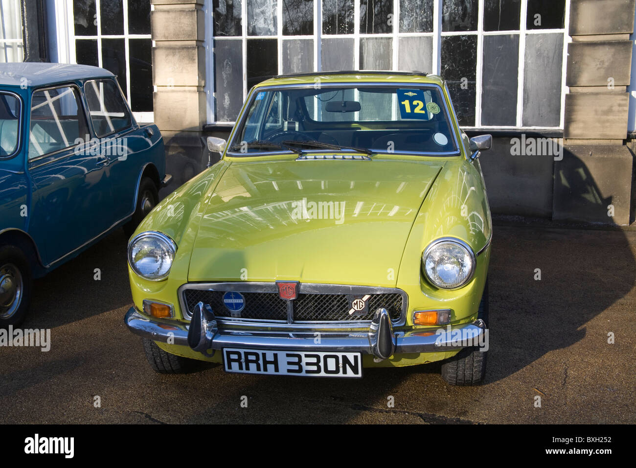 Lemon coloured classic MGB GT car for sale Stock Photo - Alamy