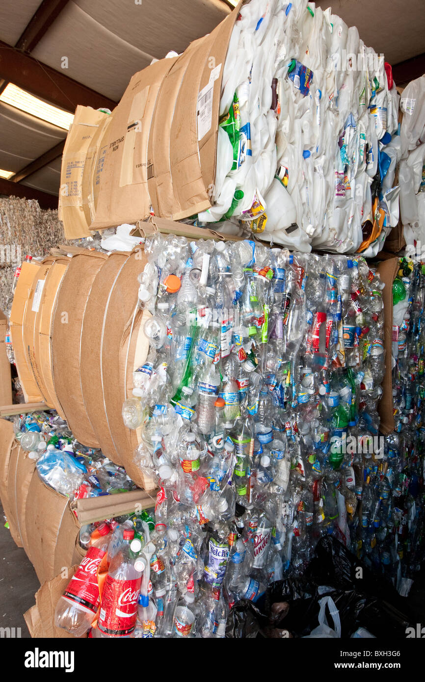 Bales of compacted plastic waste stacked high at recycling center in ...