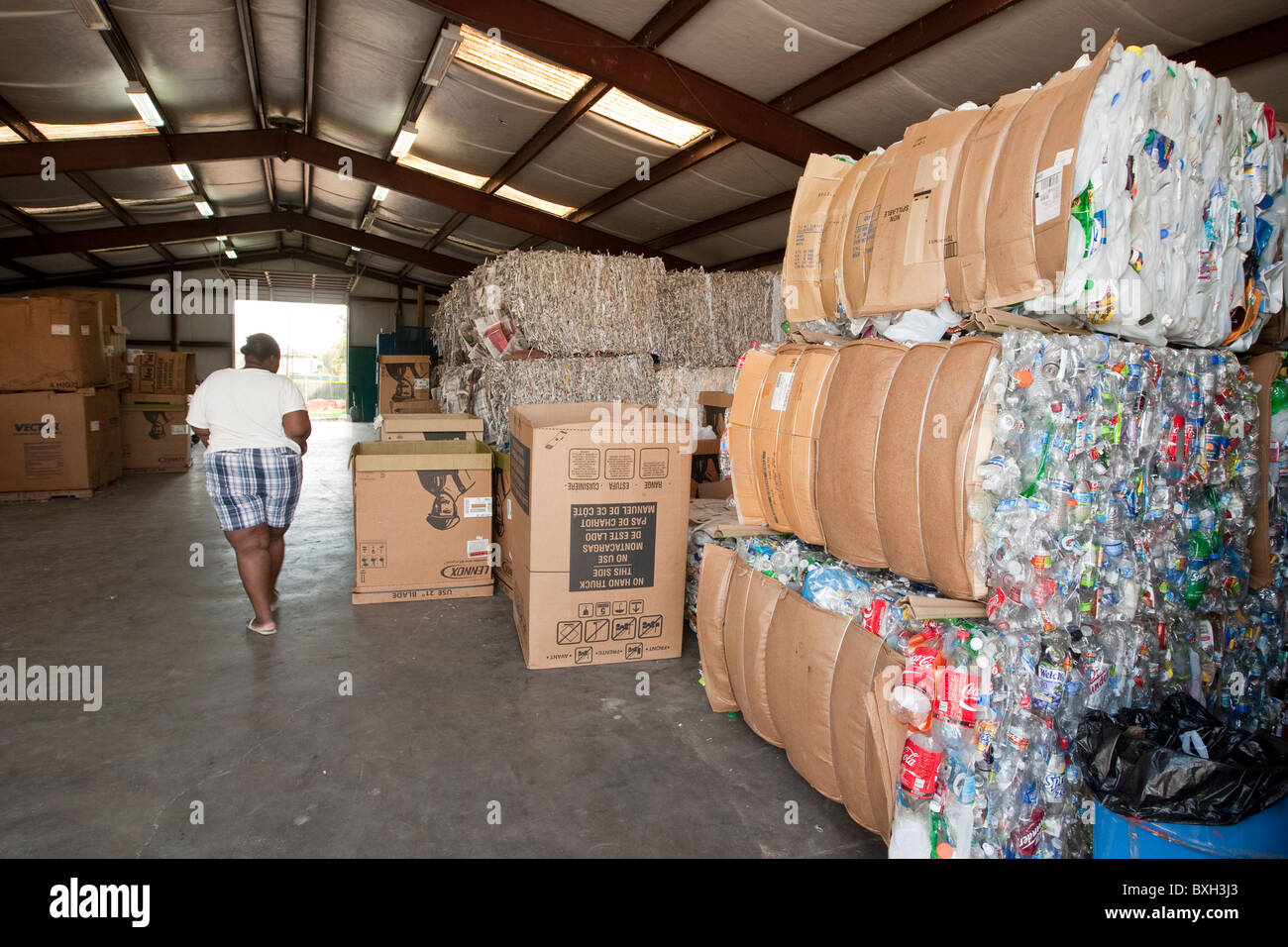 Bales of compacted paper and plastic waste stacked high at recycling ...