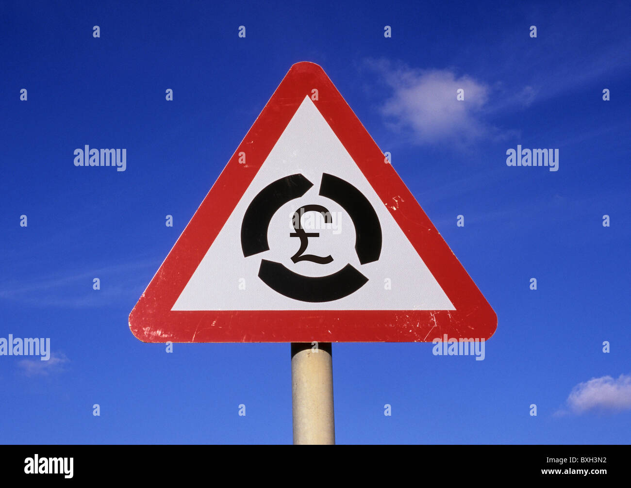 conceptual image of uk sterling pound symbol in middle of roadsign ...