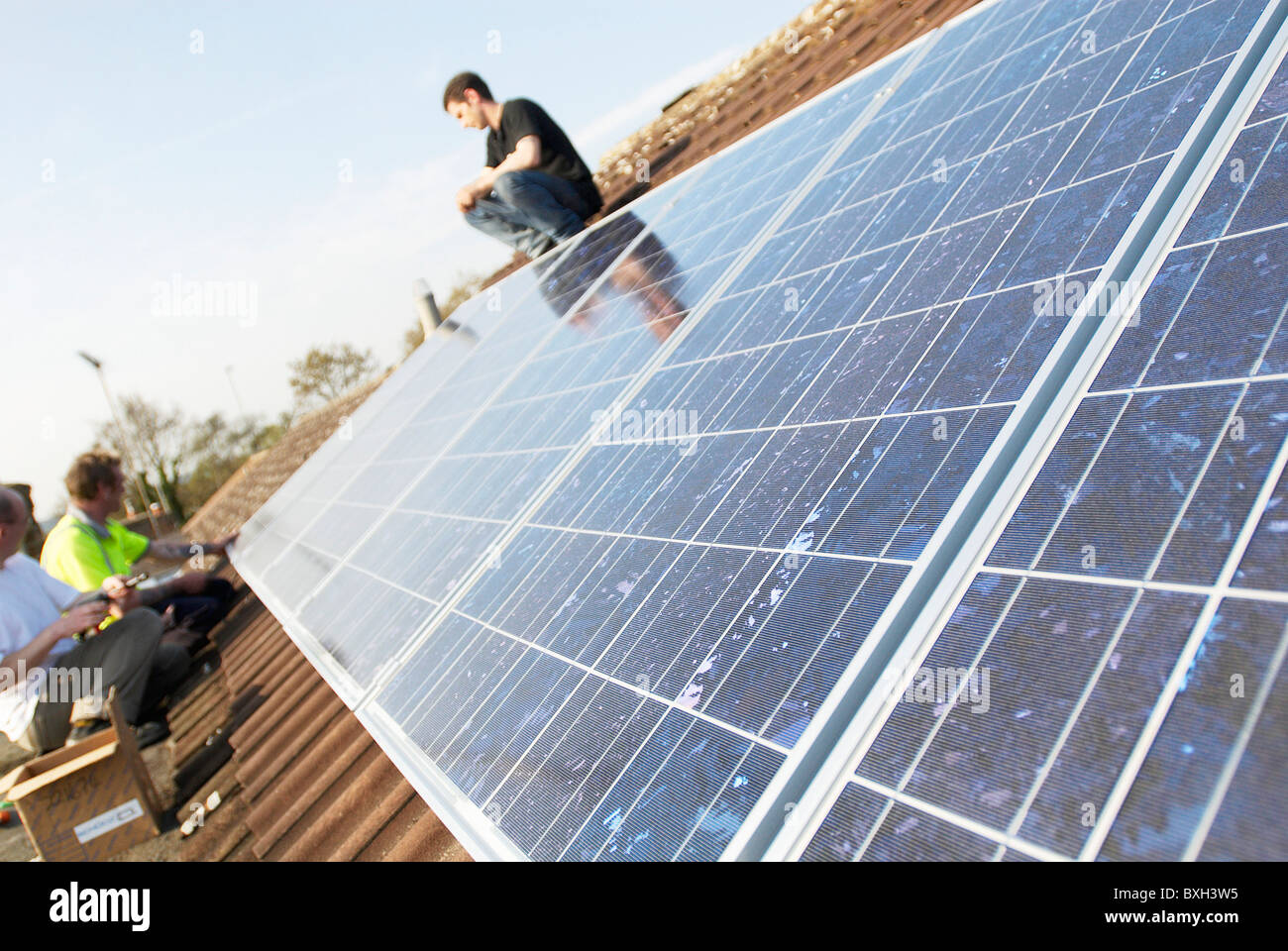 Fitting Photovoltaic panels onto the roof of a house North london UK ...