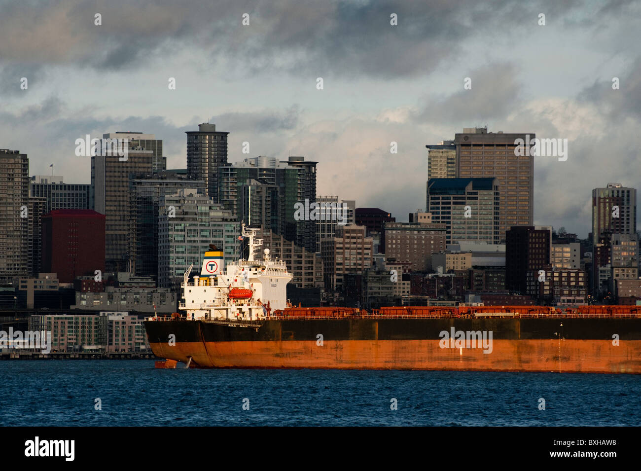 A container ship lines up to load containers at the Port of Seattle ...
