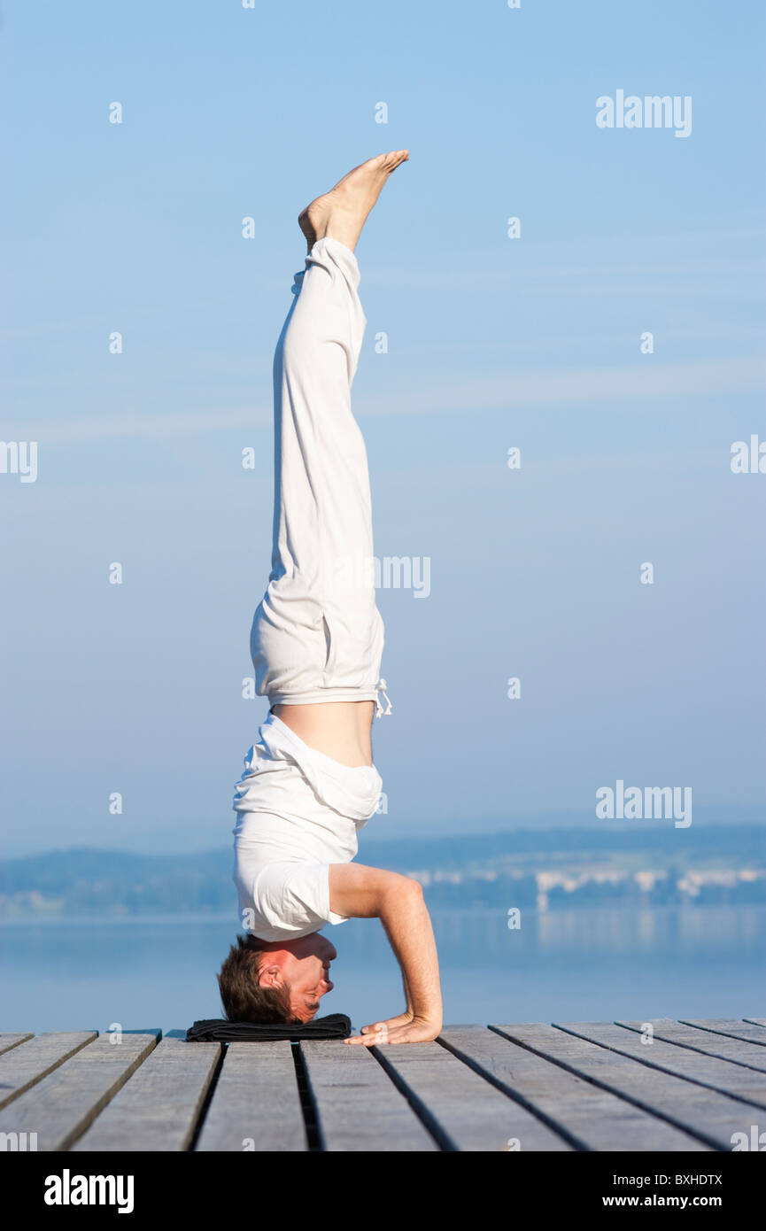 Man doing a headstand Stock Photo - Alamy