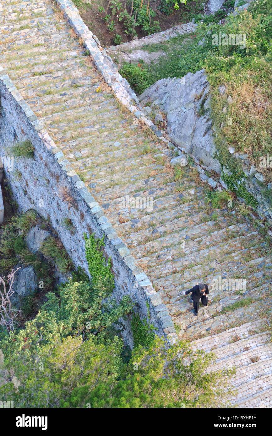 Monk in black robe walking up the stairs to the monastery Stock Photo ...
