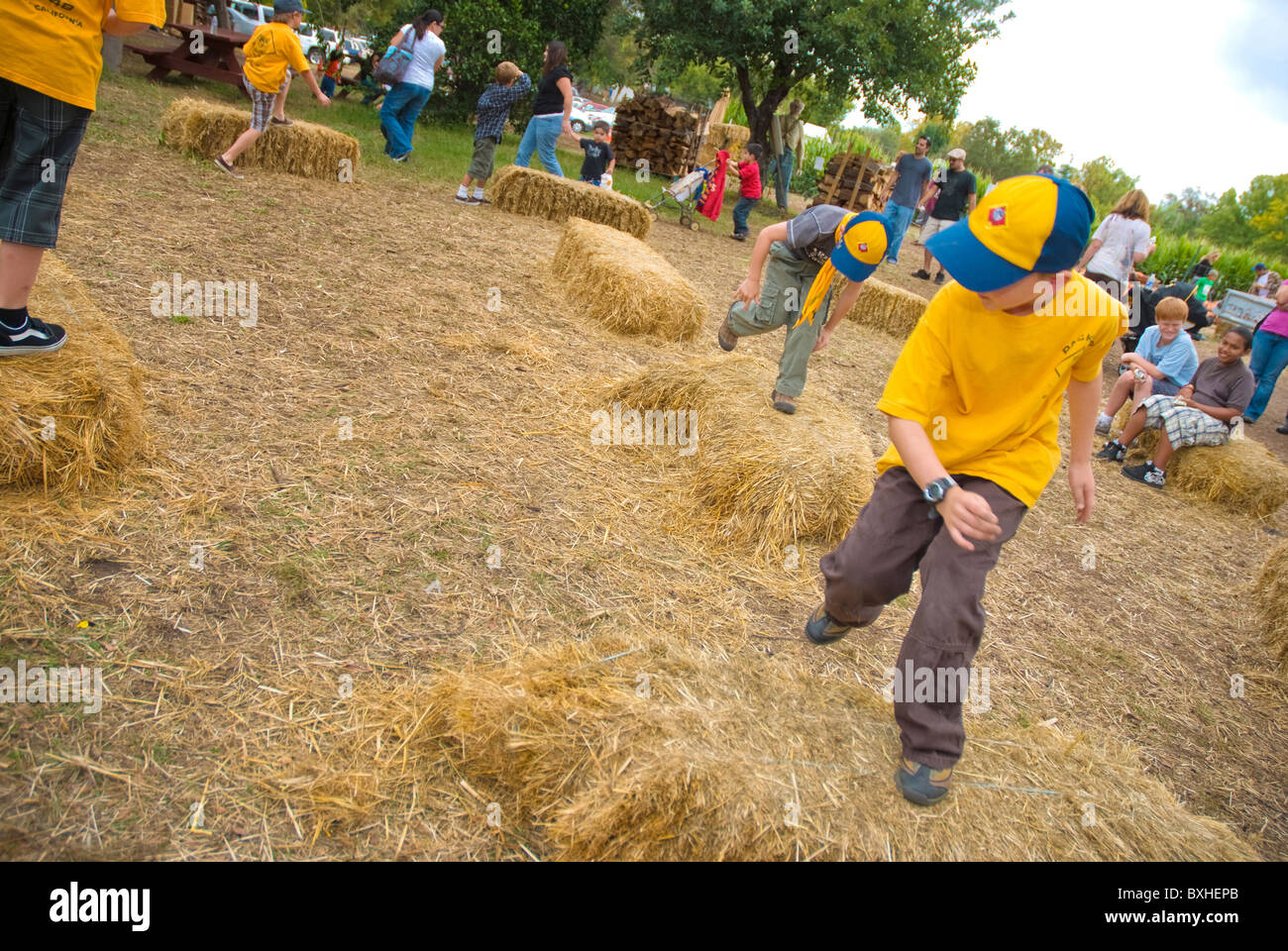 Cub Scouts jumping on bales of hay on a farm Stock Photo - Alamy