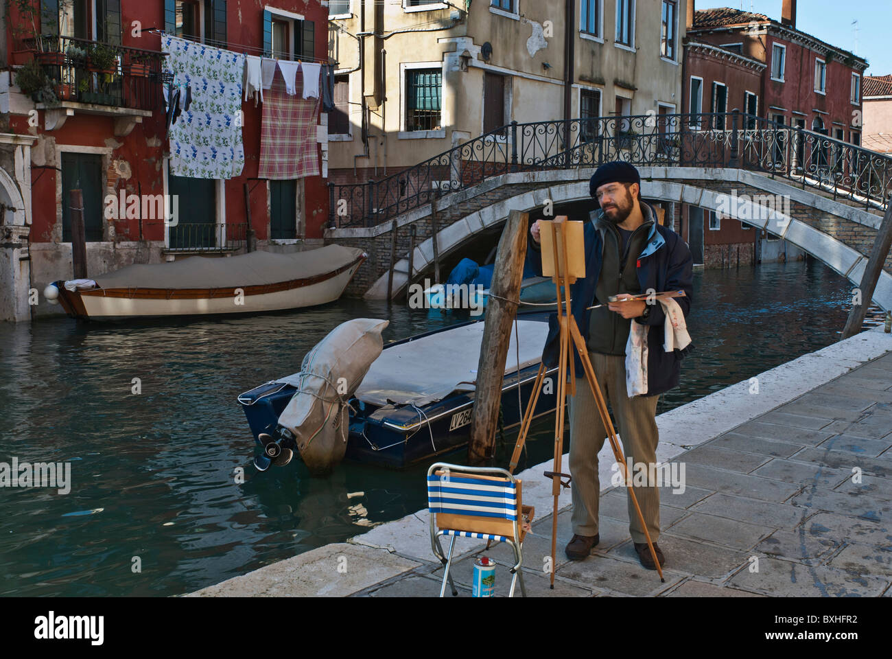Painter working by the venetian canals, Venice, Italy, Europe Stock ...