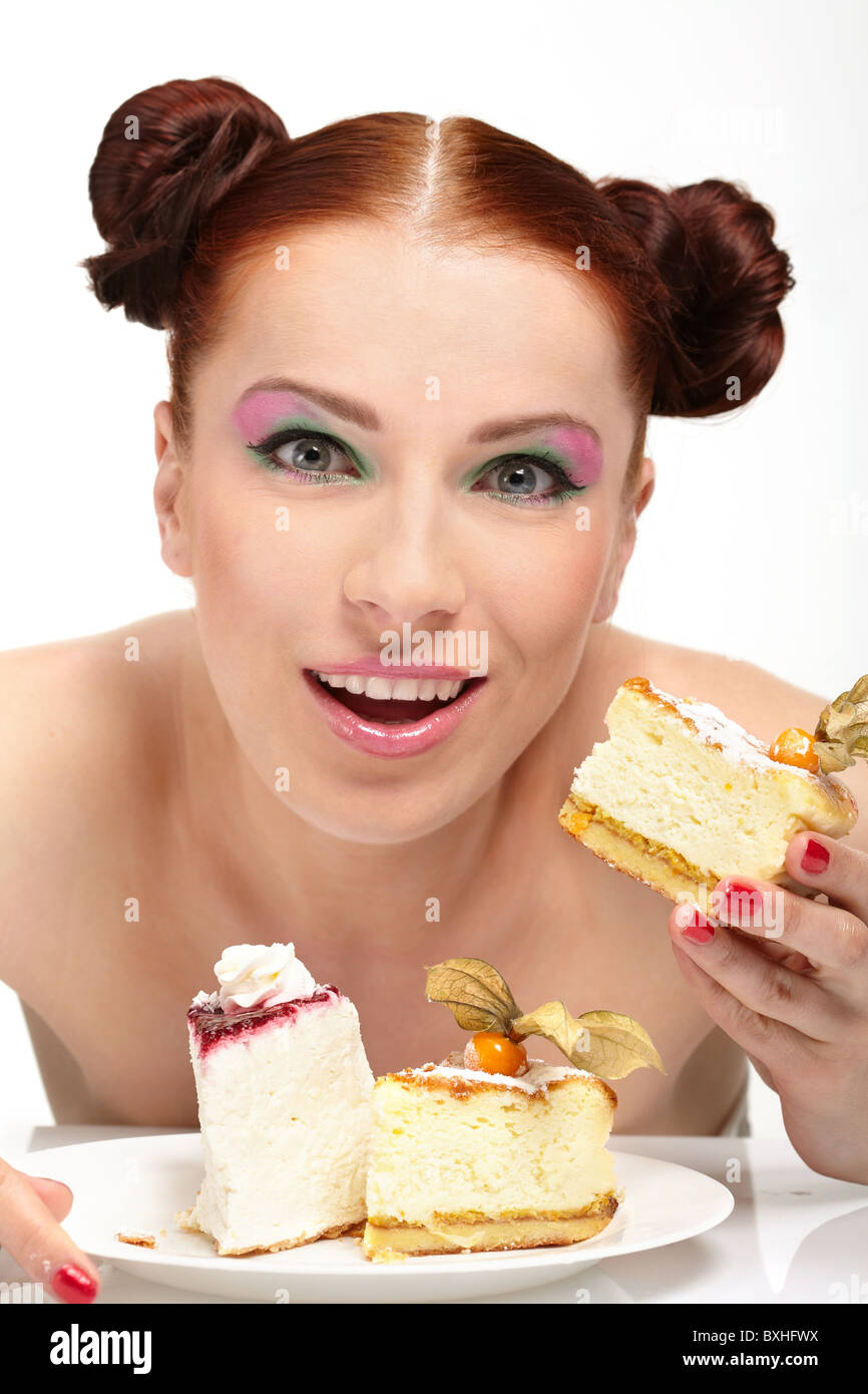 The beautiful young woman eat tasty cake Stock Photo - Alamy