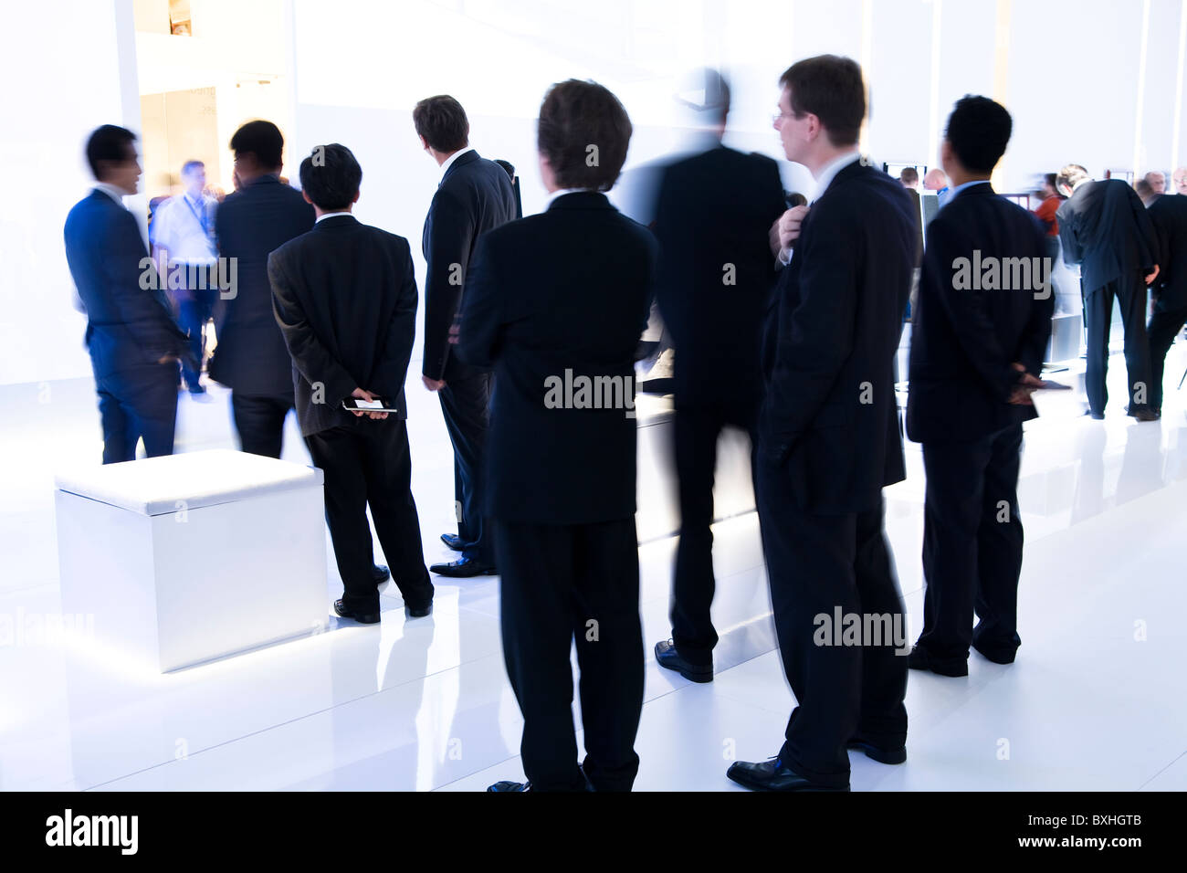 Large group of businessmen standing during presentation Stock Photo - Alamy