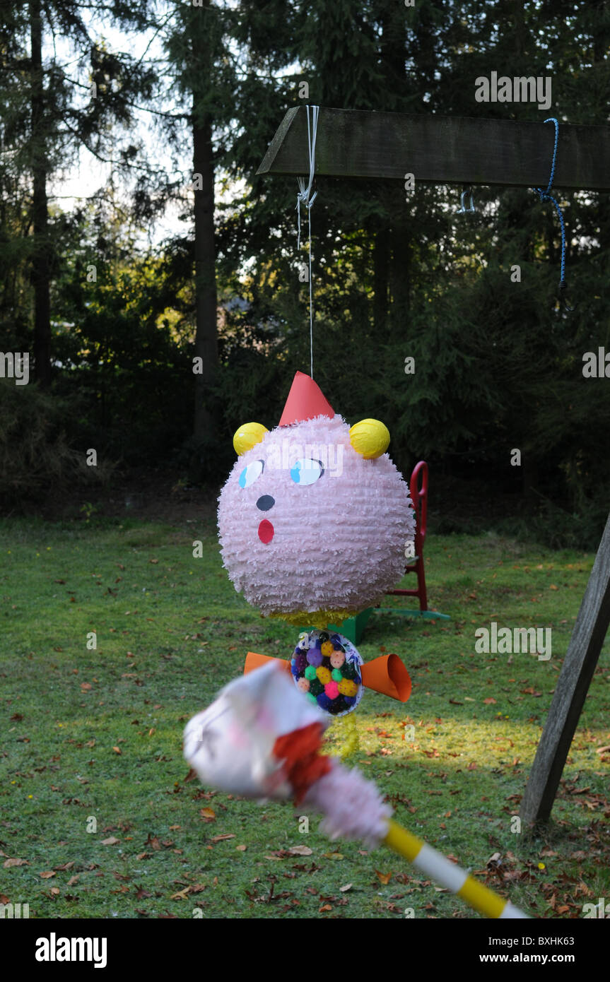pinata with stick, pink pinata in garden with decorated stick Stock ...
