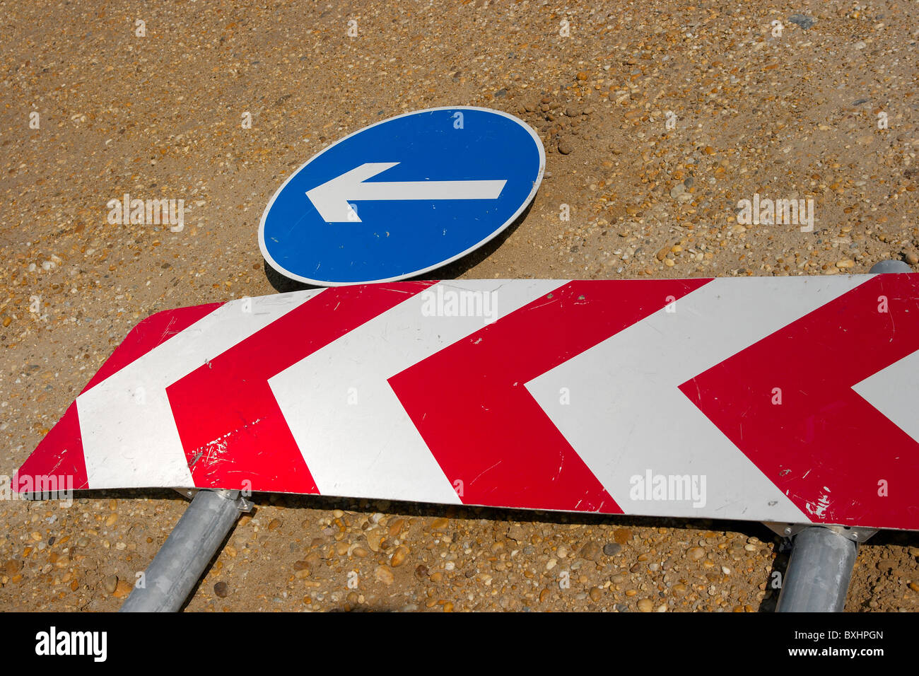 Bend traffic sign fallen on the ground Stock Photo - Alamy
