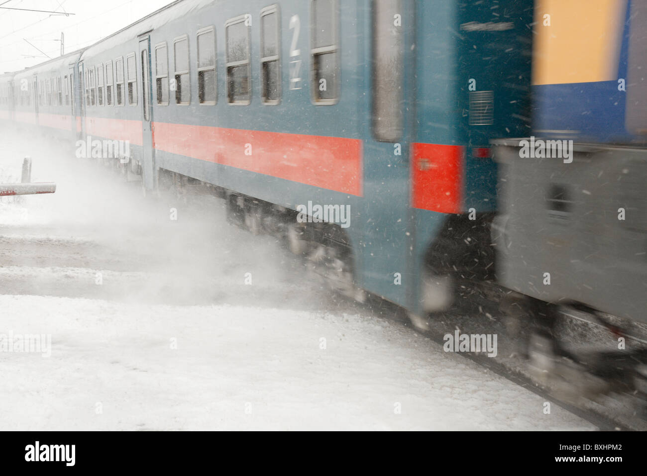 Train passing by in snow storm with motion blur Stock Photo - Alamy