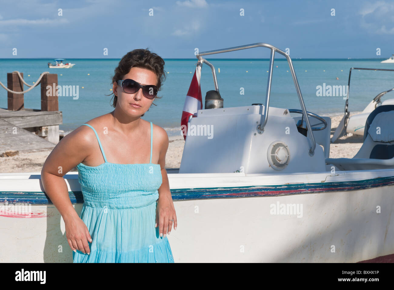 Woman near boat in Aruba Stock Photo - Alamy