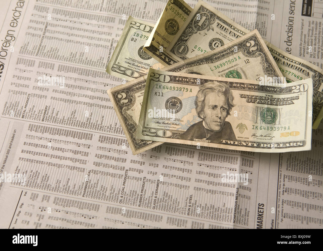Dollar bills and newspaper Stock Photo - Alamy