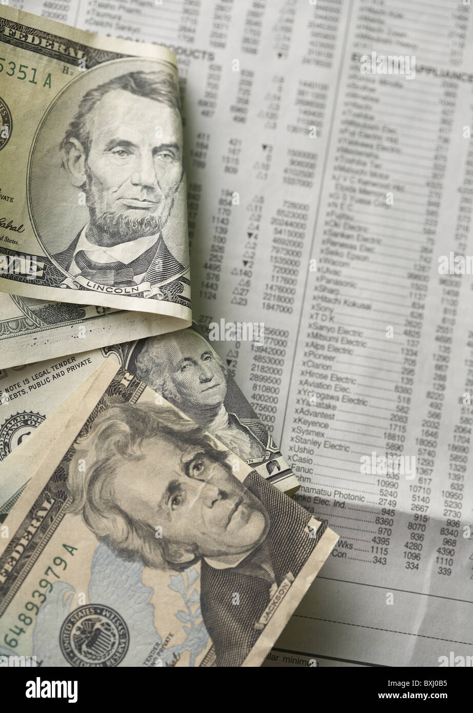 Dollar bills and newspaper Stock Photo - Alamy