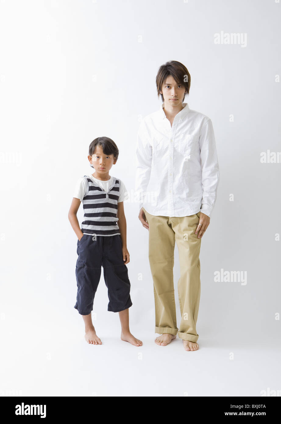 Father and son standing side by side Stock Photo - Alamy