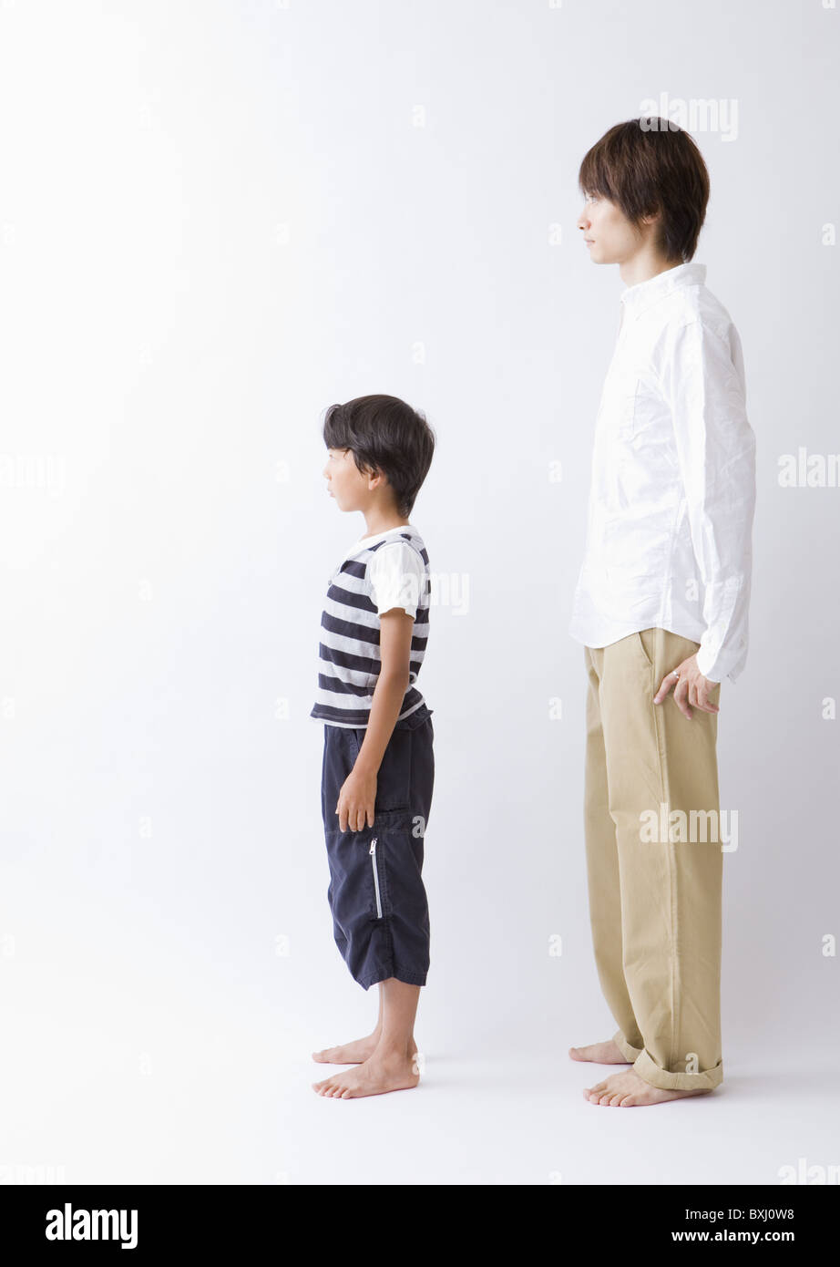 Father and son standing side by side Stock Photo - Alamy