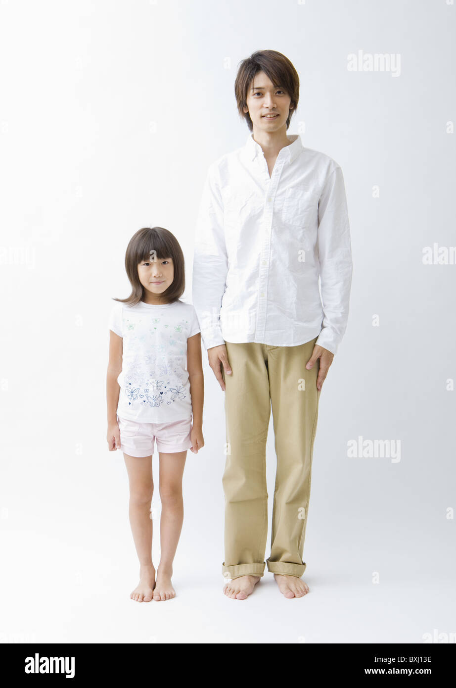 Father and daughter standing side by side Stock Photo - Alamy