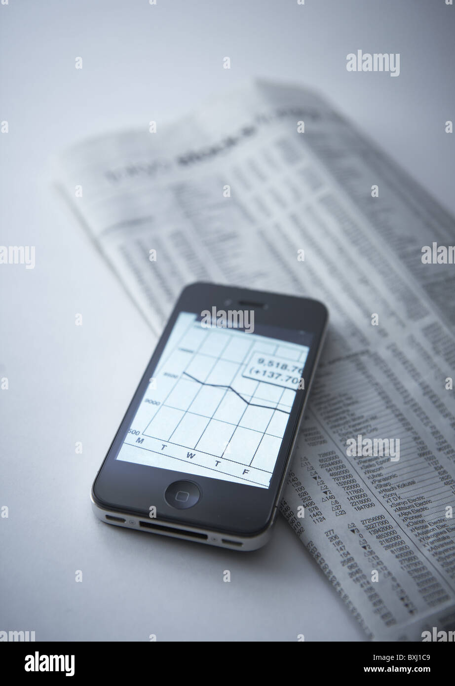 Smartphone and newspaper Stock Photo - Alamy