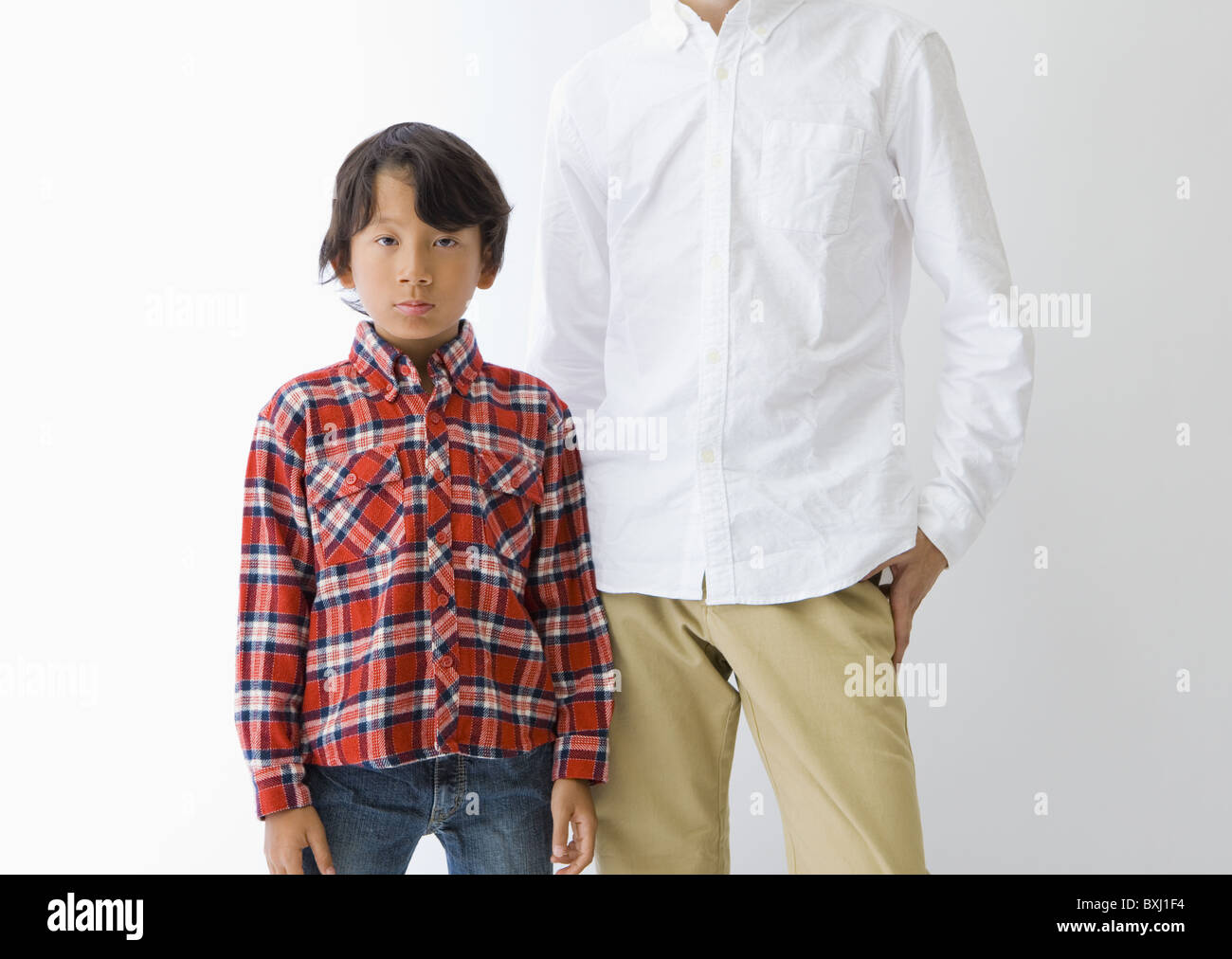 Father and son standing side by side Stock Photo - Alamy