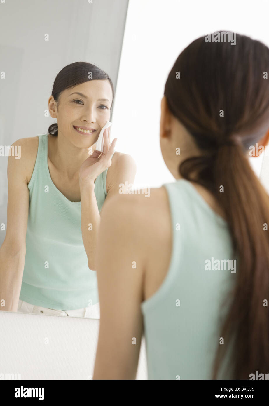 A woman taking care of her face Stock Photo - Alamy