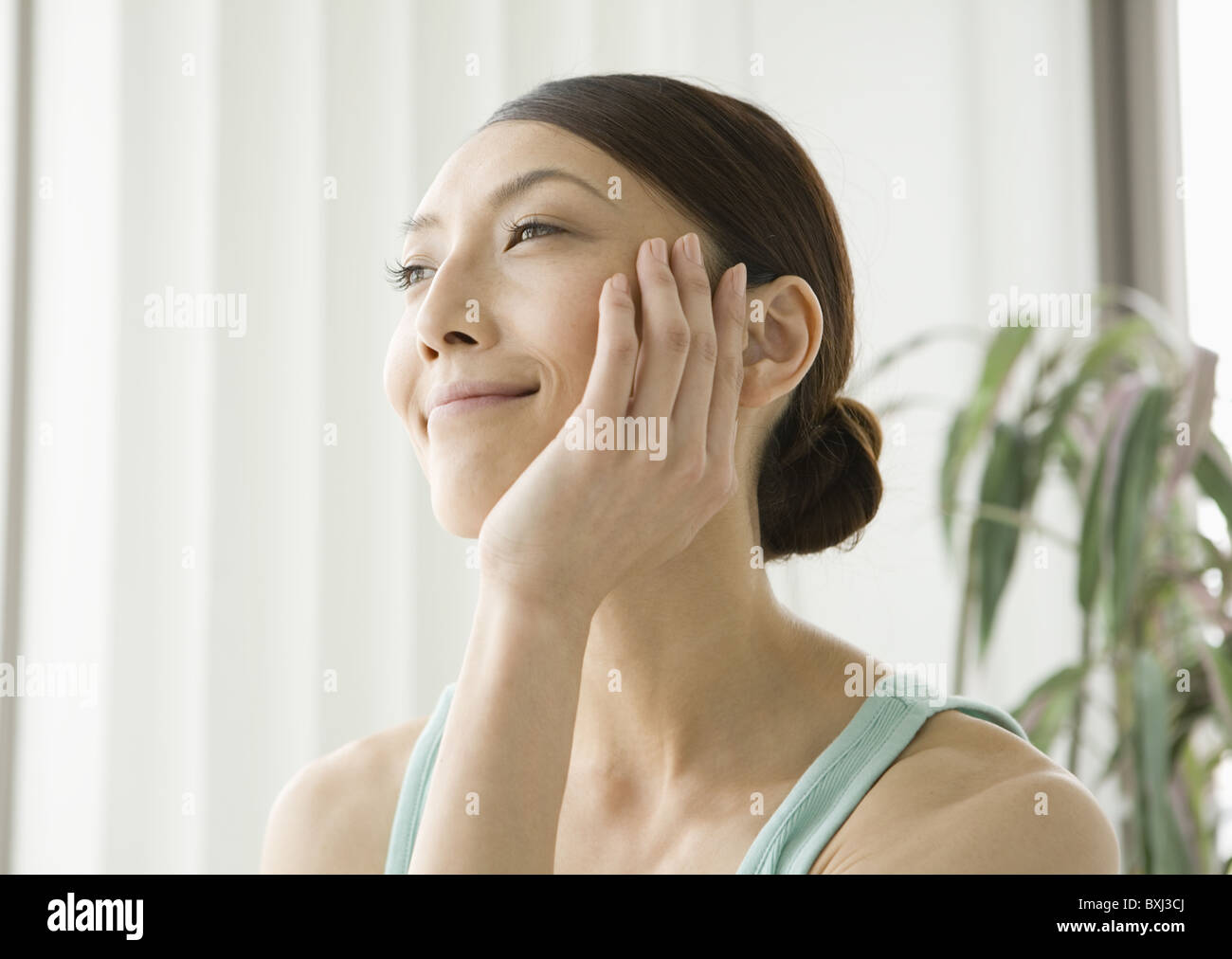A woman taking care of her face Stock Photo - Alamy
