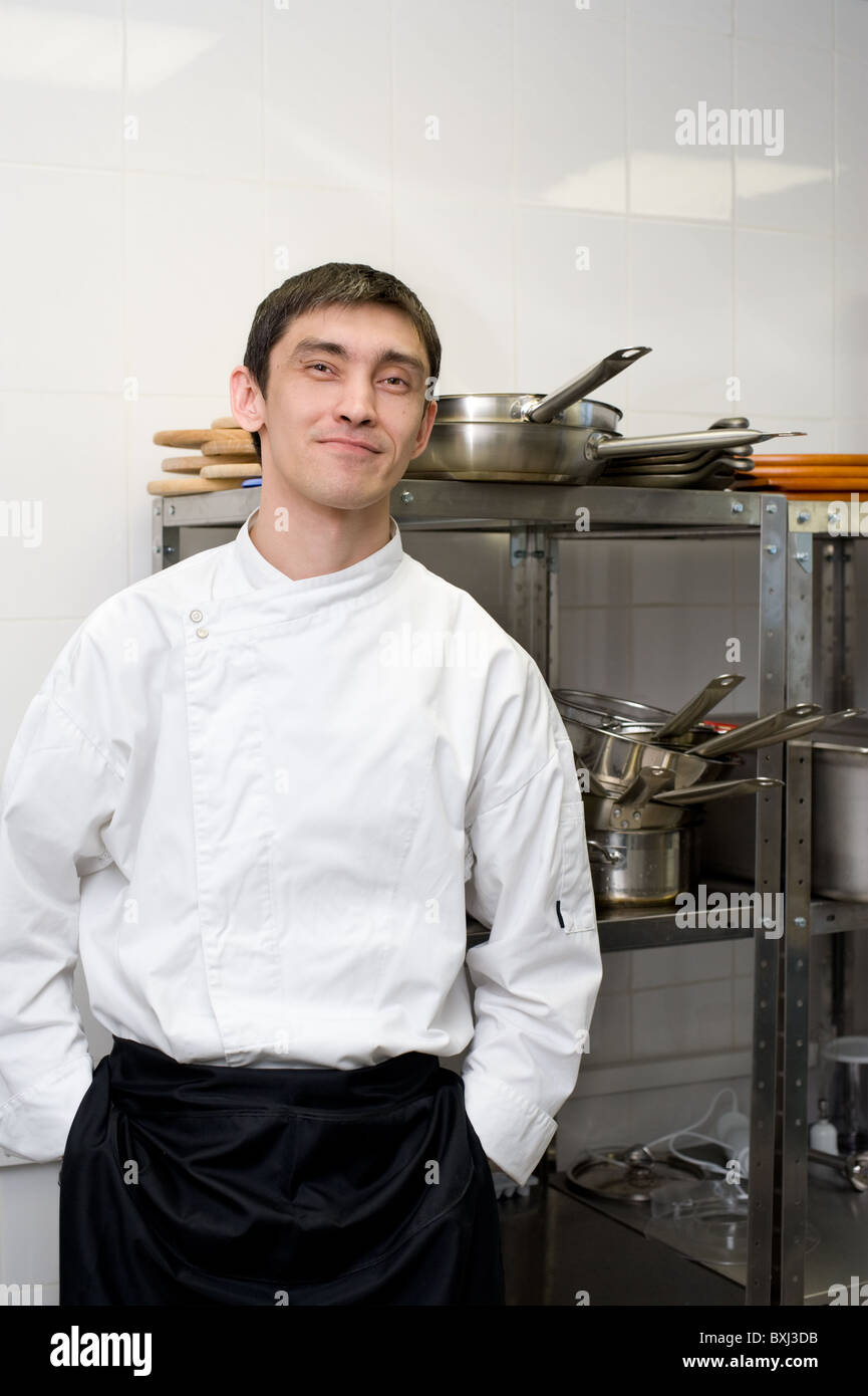 european chef with his hands in pockets looks into camera Stock Photo ...
