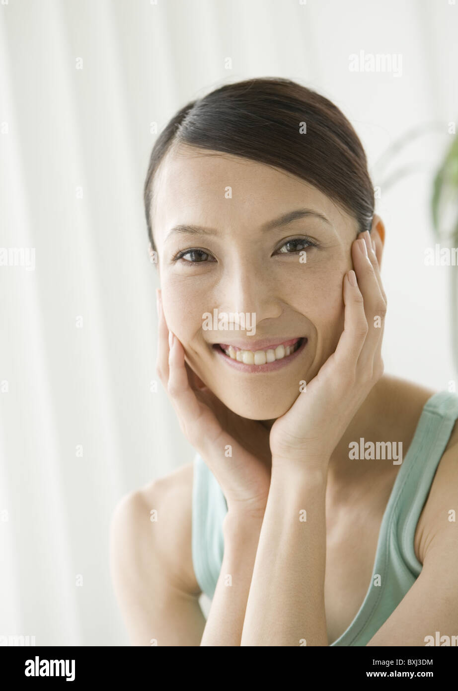 A woman taking care of her face Stock Photo - Alamy