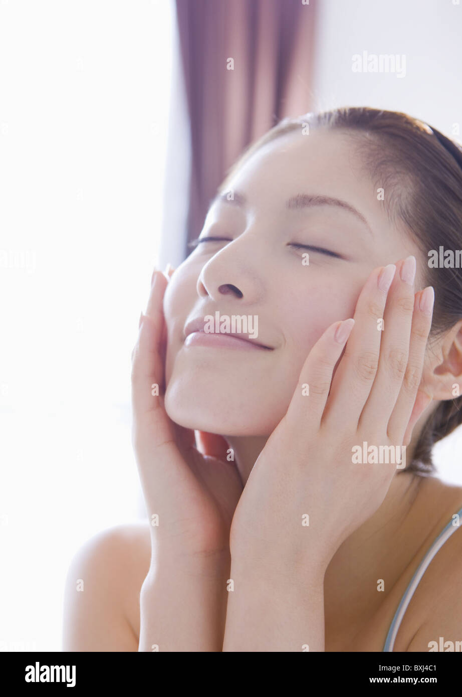 Woman taking care of her face Stock Photo - Alamy