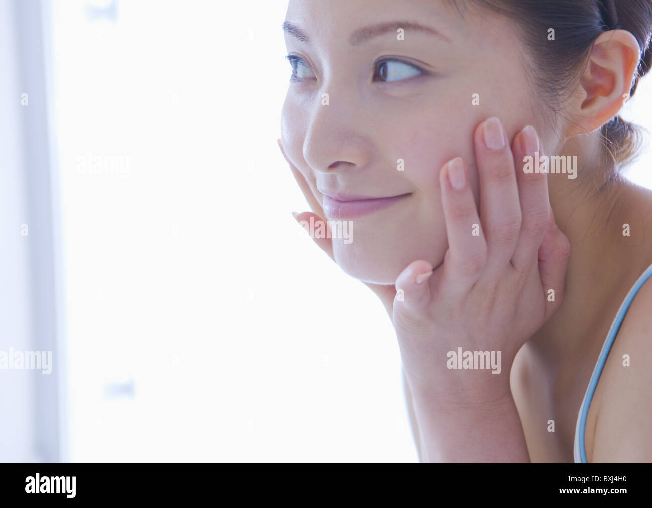 Woman taking care of her face Stock Photo - Alamy